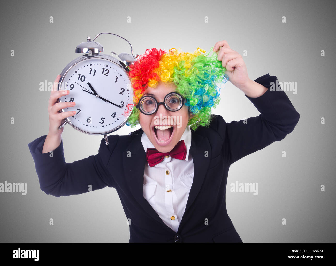 Funny clown with clock on white Stock Photo - Alamy