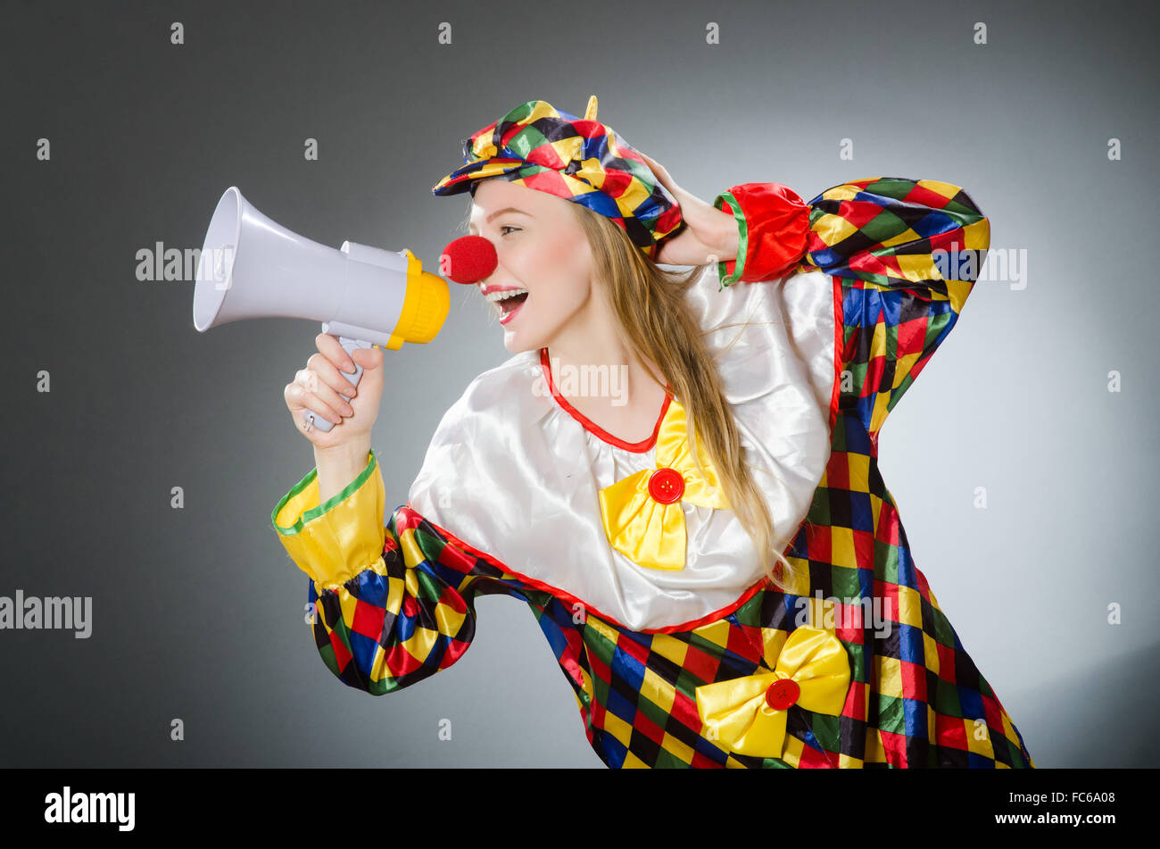 Clown with loudspeaker isolated on white Stock Photo - Alamy
