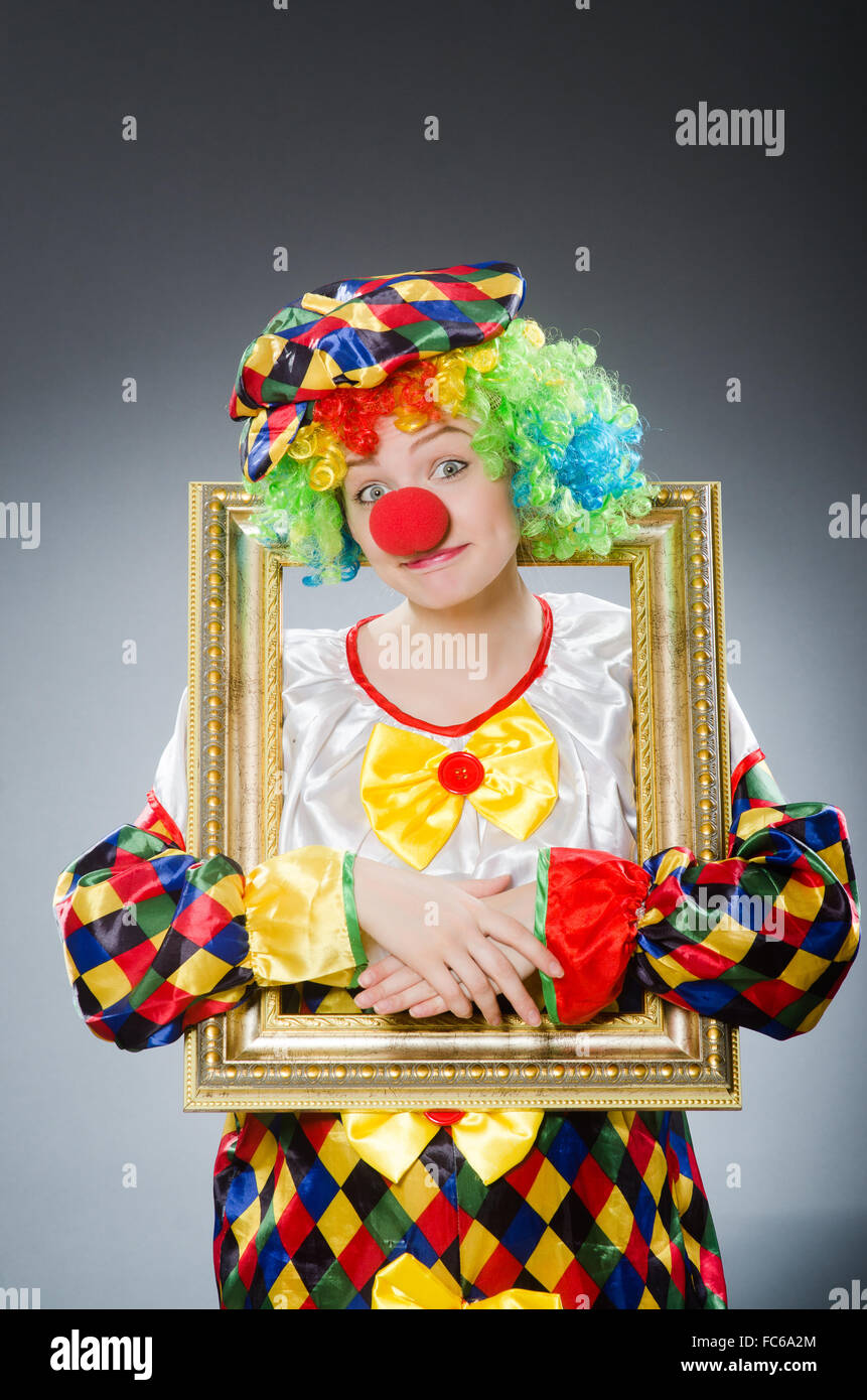 Clown with picture frame in funny concept Stock Photo - Alamy