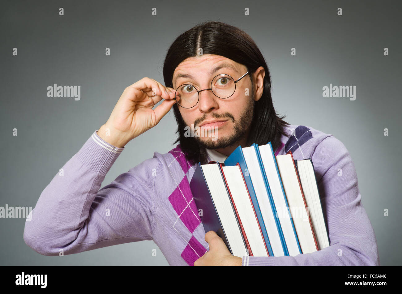 Young student with book in learning concept Stock Photo - Alamy