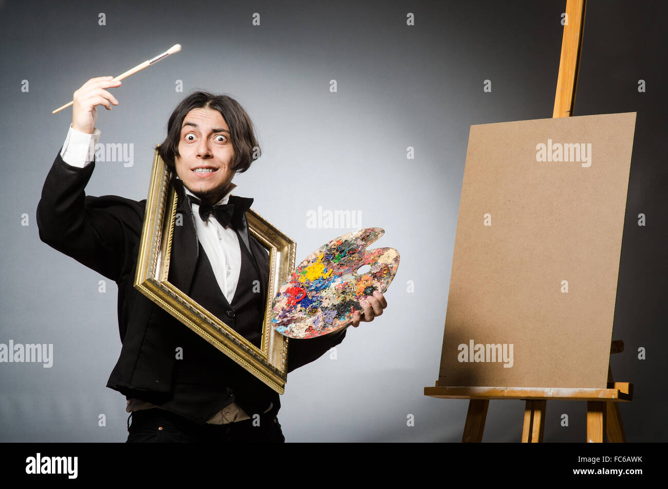 Funny artist in dark studio Stock Photo - Alamy