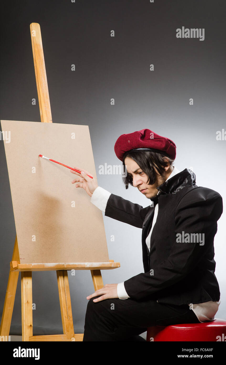 Funny artist in dark studio Stock Photo - Alamy