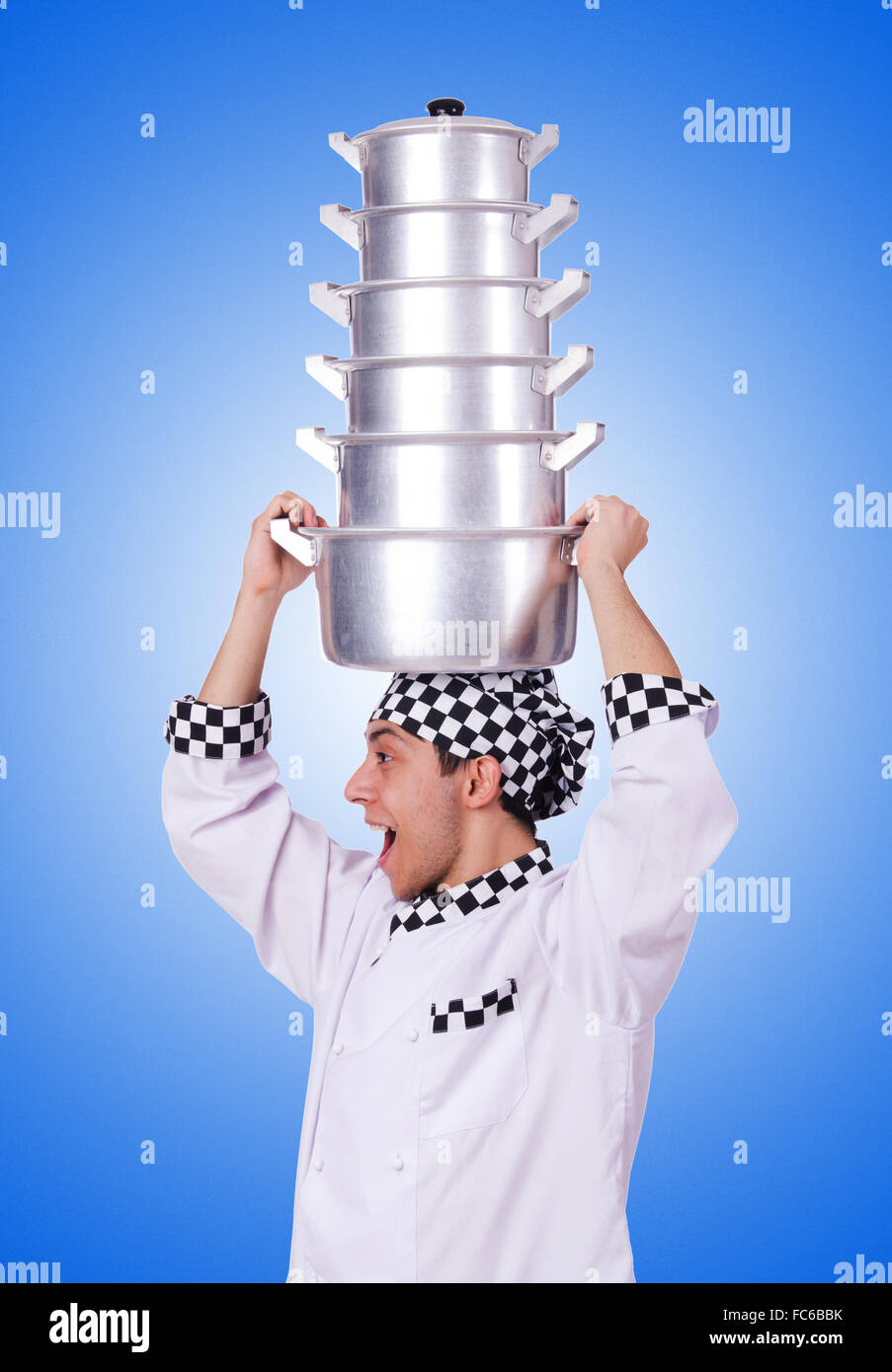 Cook with stack of pots on white Stock Photo - Alamy