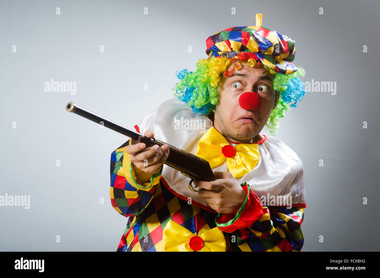 Clown with rifle isolated on white Stock Photo - Alamy