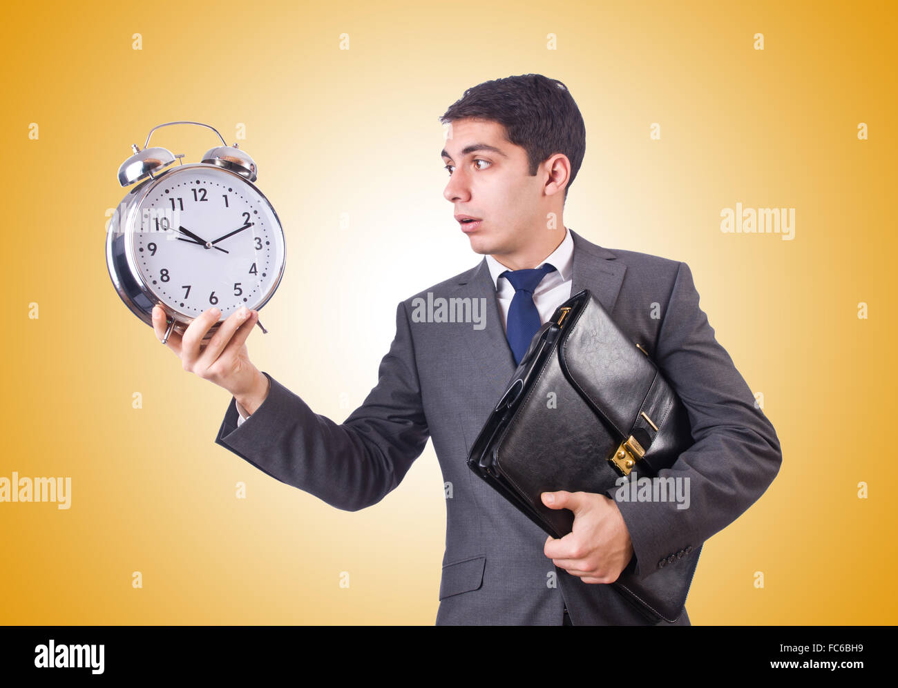 Businessman with clock isolated on white Stock Photo - Alamy