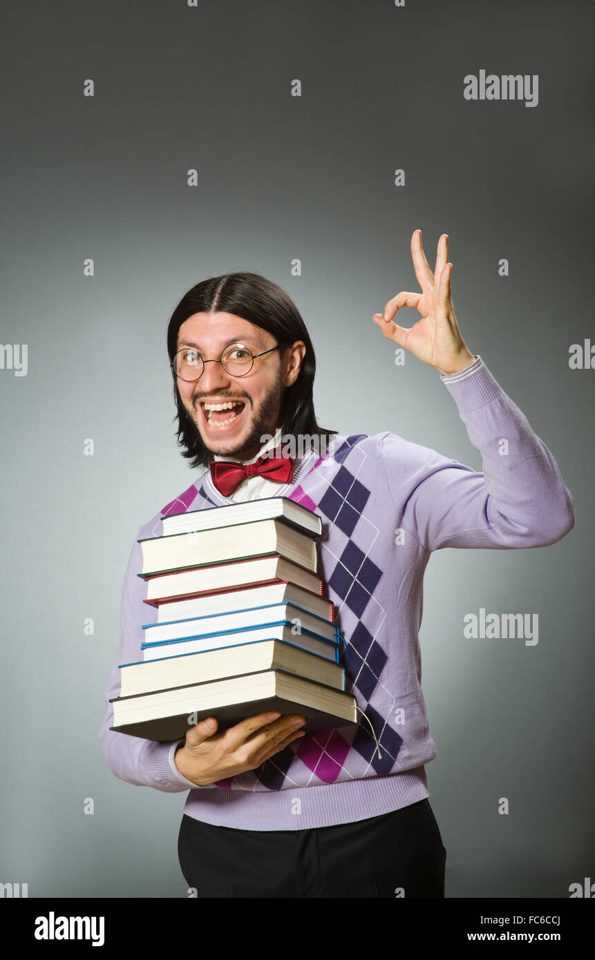 Young student with book in learning concept Stock Photo - Alamy