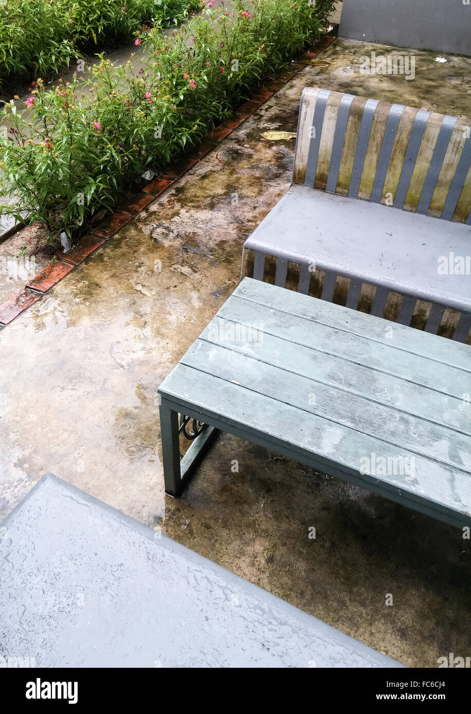 Concrete bench set with rain for relaxing in the park Stock Photo - Alamy