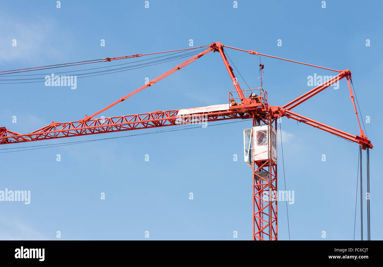 Red modern crane in the construction site under clear blue sky Stock ...