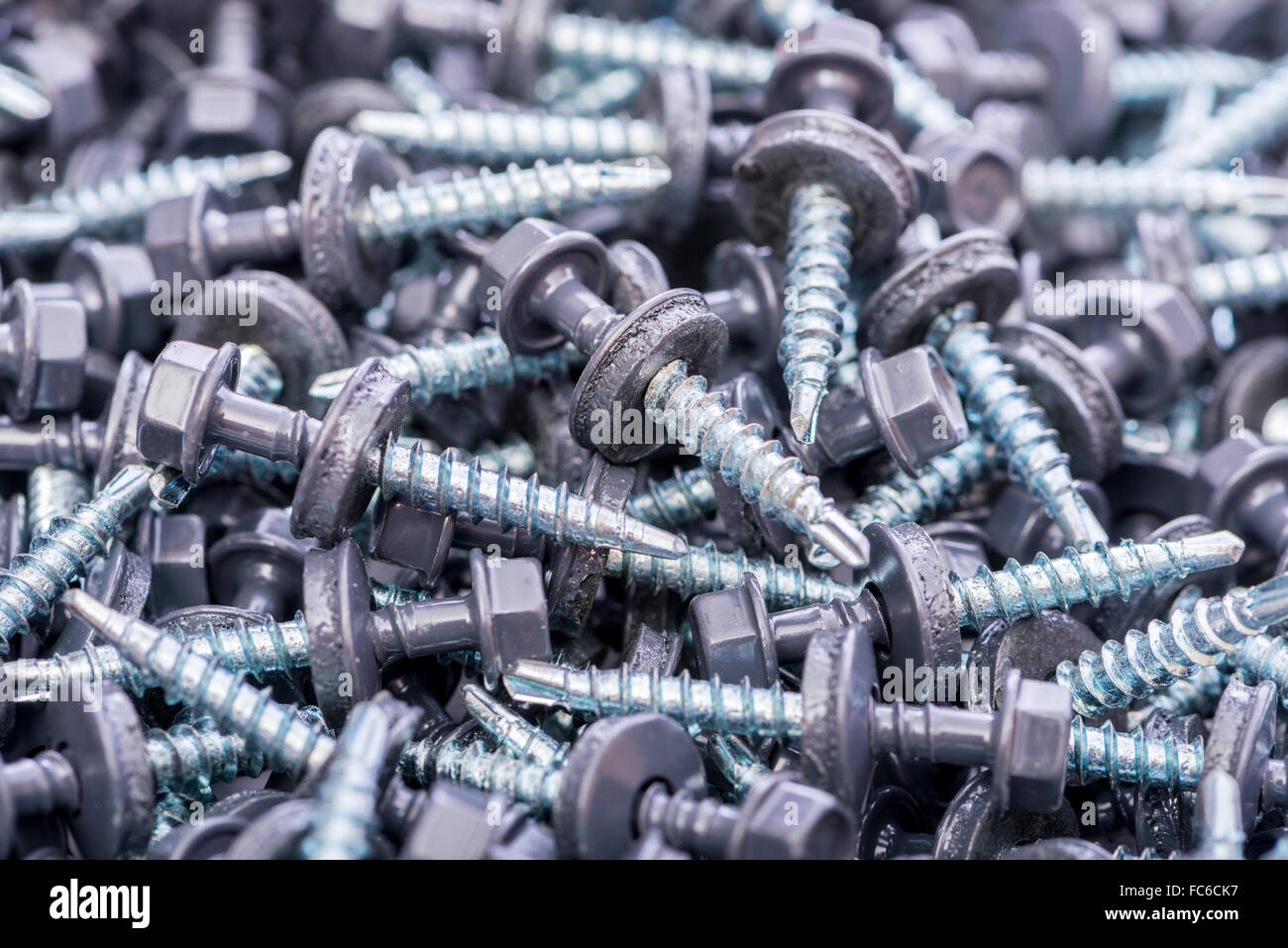 Many screws arranged as background Stock Photo - Alamy