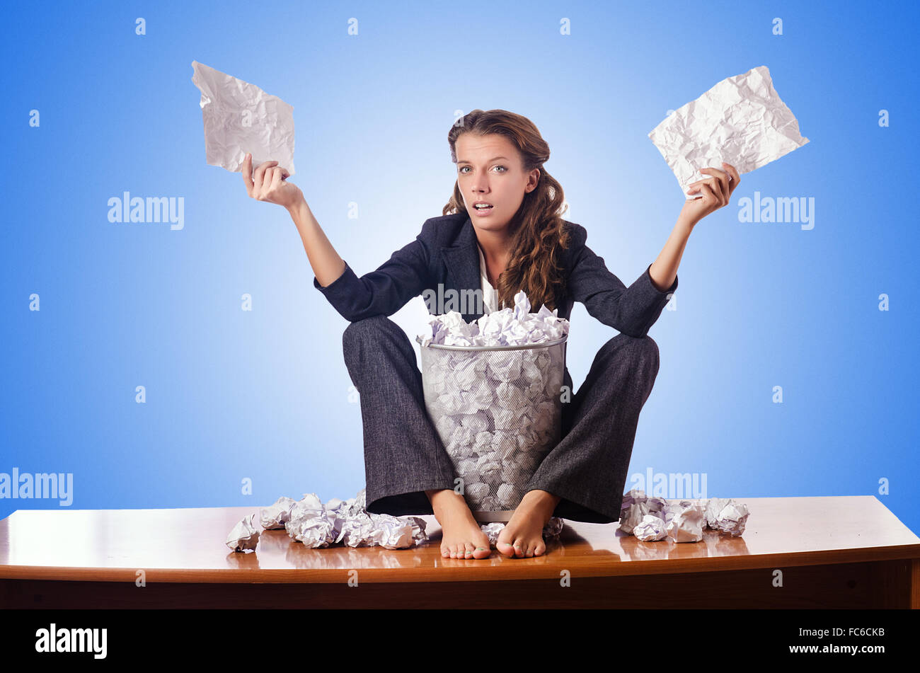 Woman with lots of discarded paper Stock Photo - Alamy