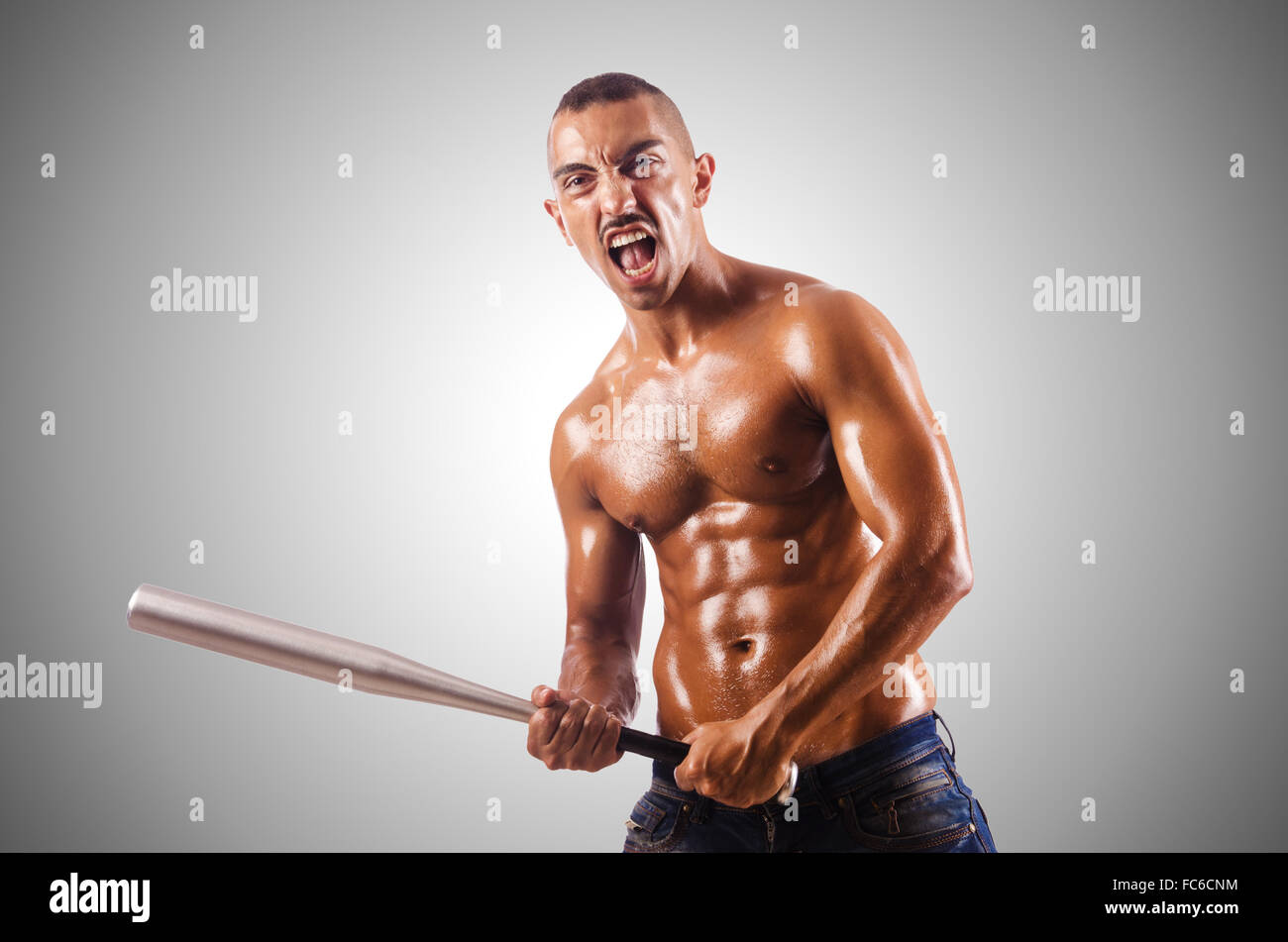 Muscular man with baseball bat Stock Photo - Alamy