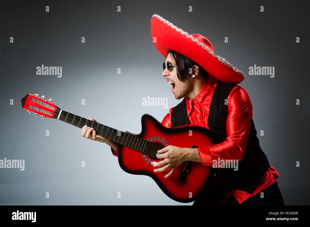 Mexican guitar player in red Stock Photo - Alamy