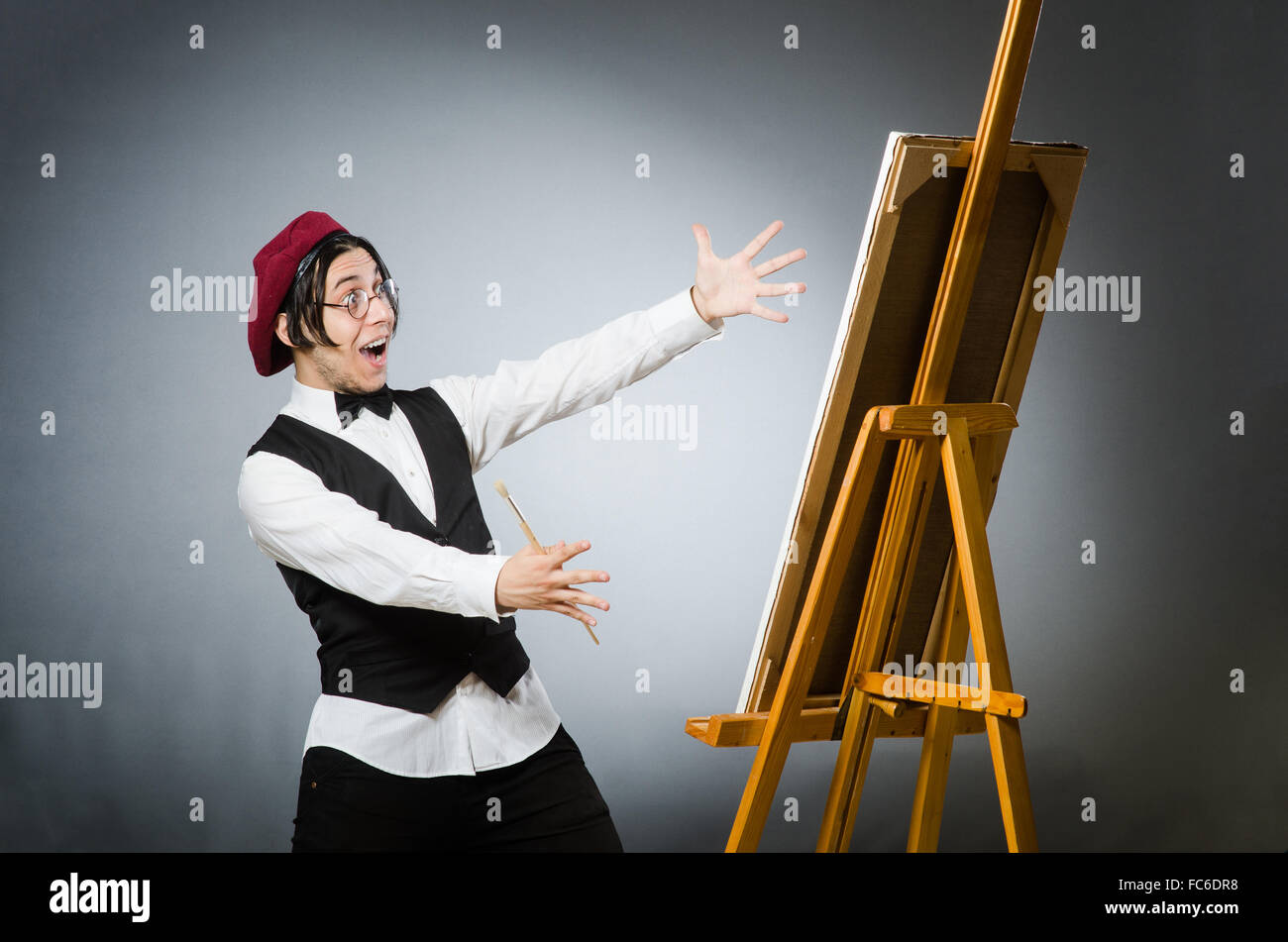 Funny artist in dark studio Stock Photo - Alamy