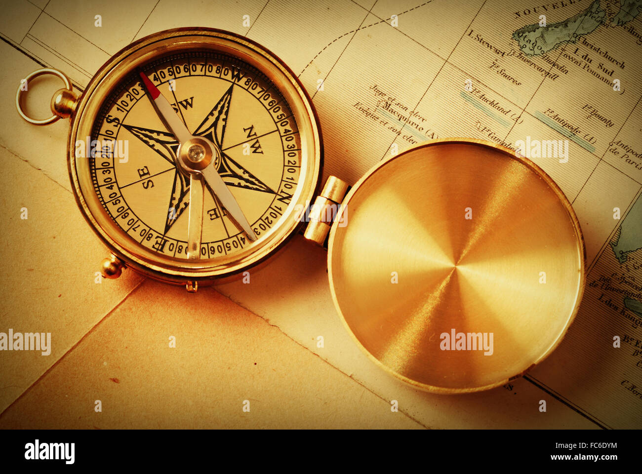 Antique brass compass over old map Stock Photo - Alamy
