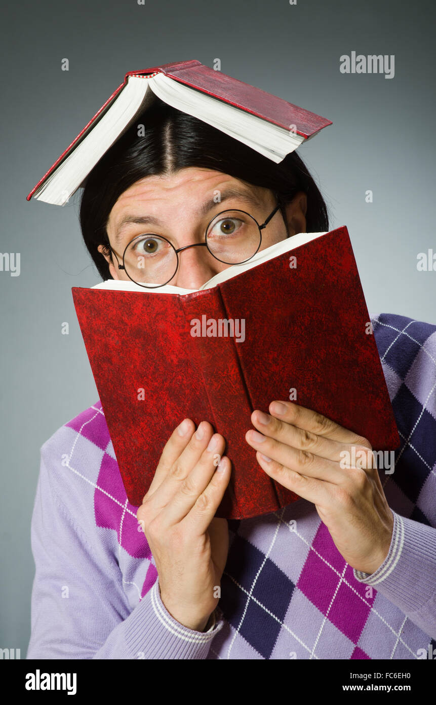 Young student with book in learning concept Stock Photo - Alamy