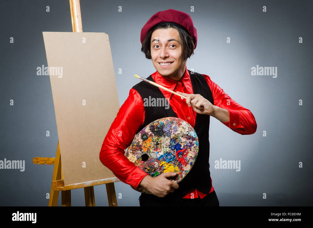 Funny artist in dark studio Stock Photo - Alamy