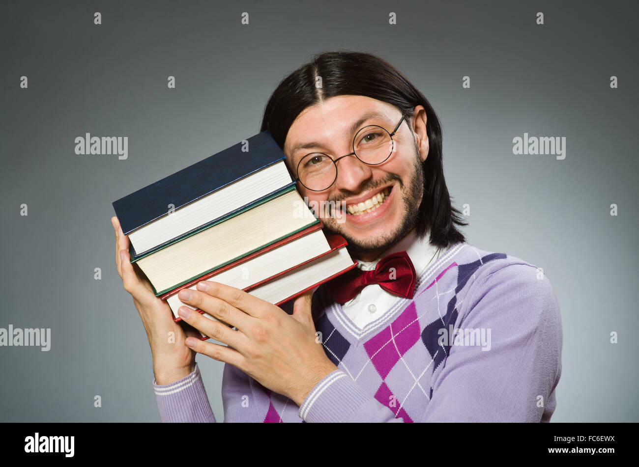 Young student with book in learning concept Stock Photo - Alamy