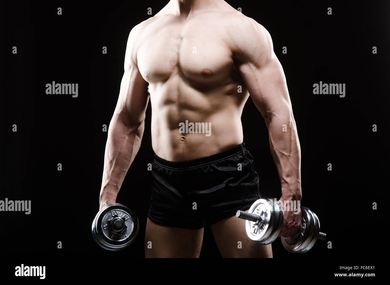 Muscular ripped bodybuilder with dumbbells Stock Photo - Alamy