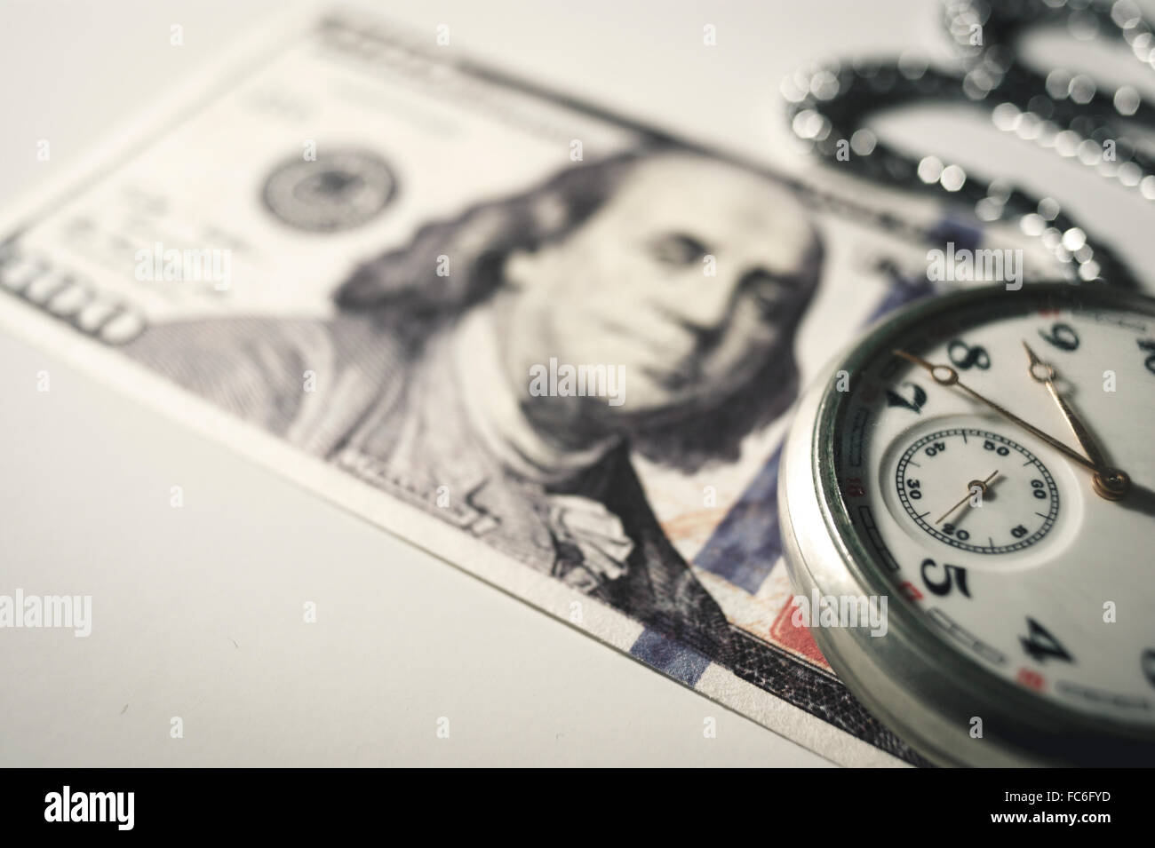 100 dollar bill and chain watch. Dollar is defocused and chain watch is ...