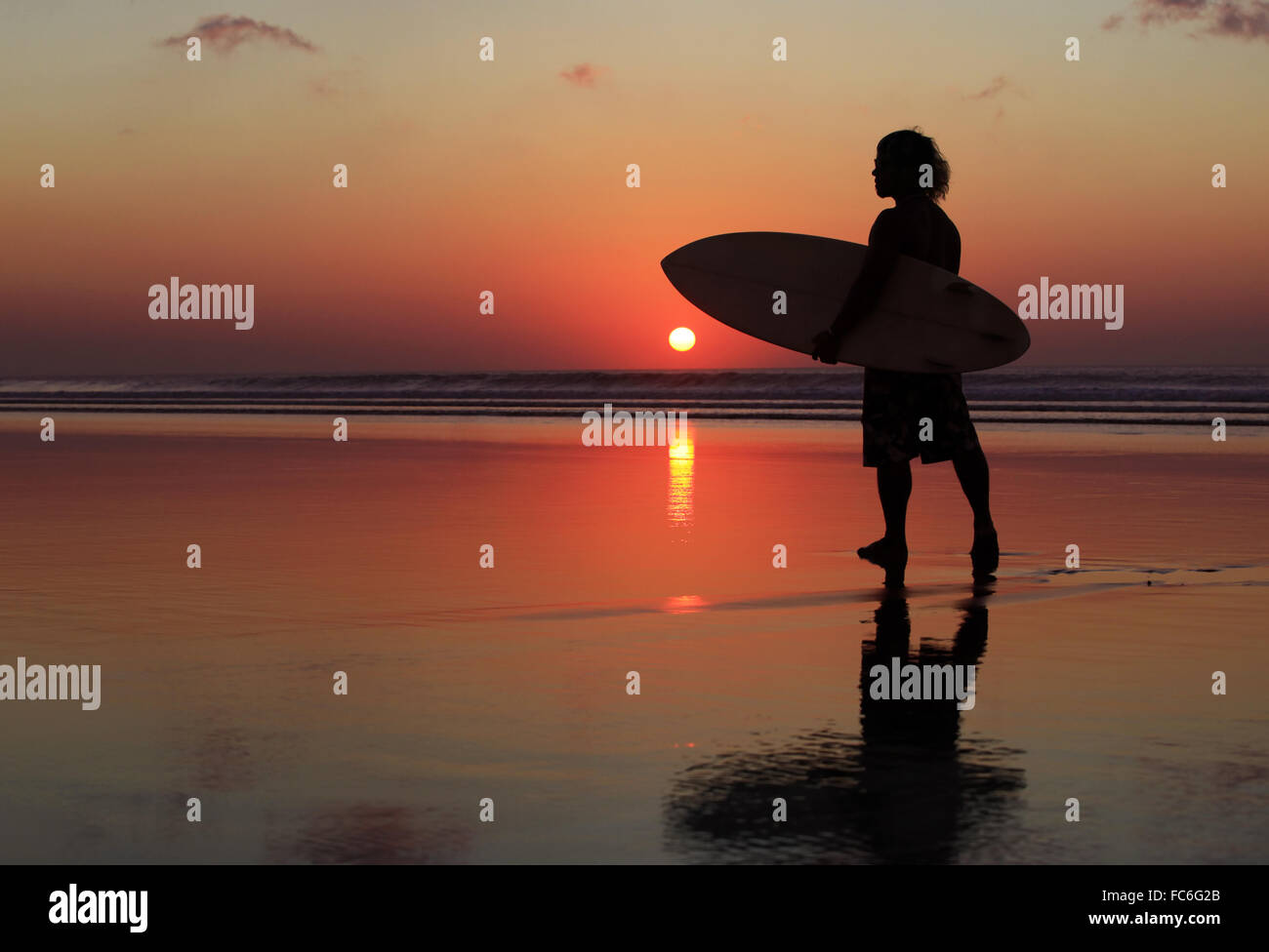 Surfer on sunset Stock Photo - Alamy