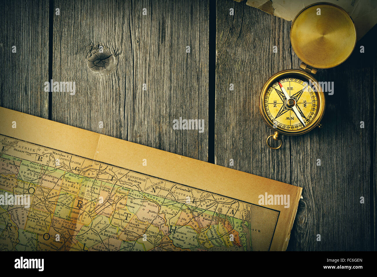 Antique compass over old map Stock Photo - Alamy