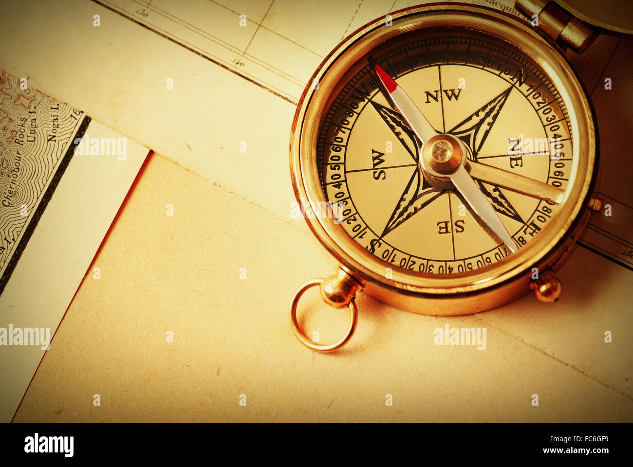 Antique brass compass over old map Stock Photo - Alamy