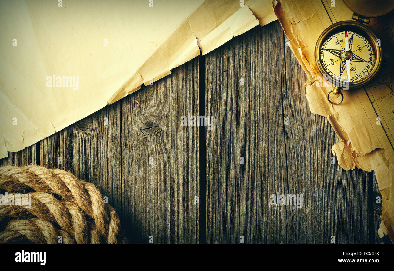 Antique compass and rope over old map Stock Photo - Alamy