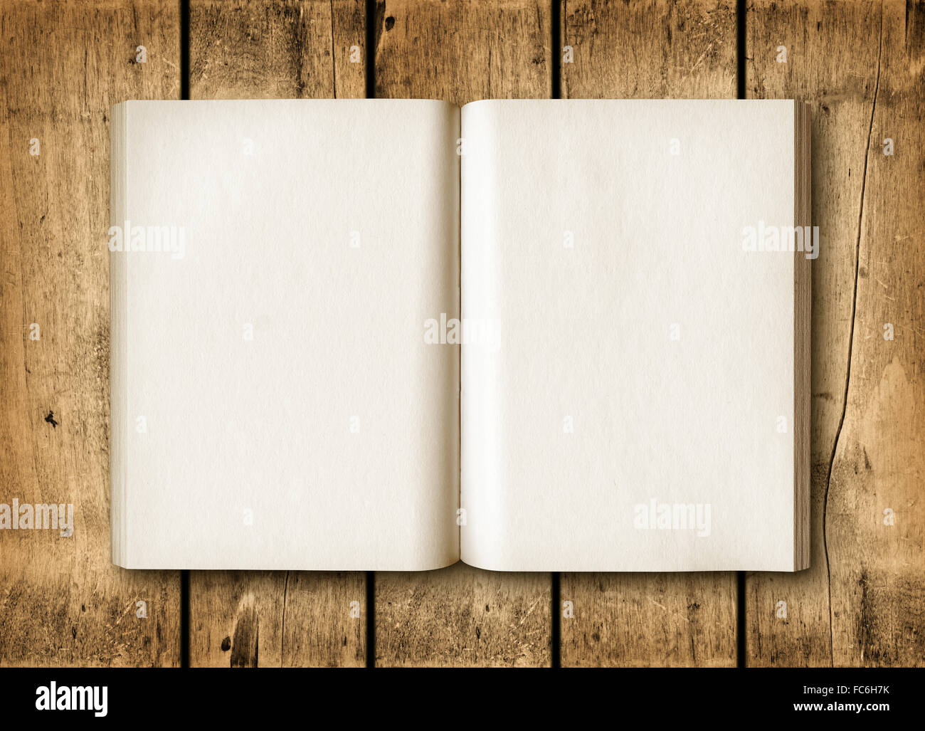Open book on a brown wood table Stock Photo - Alamy