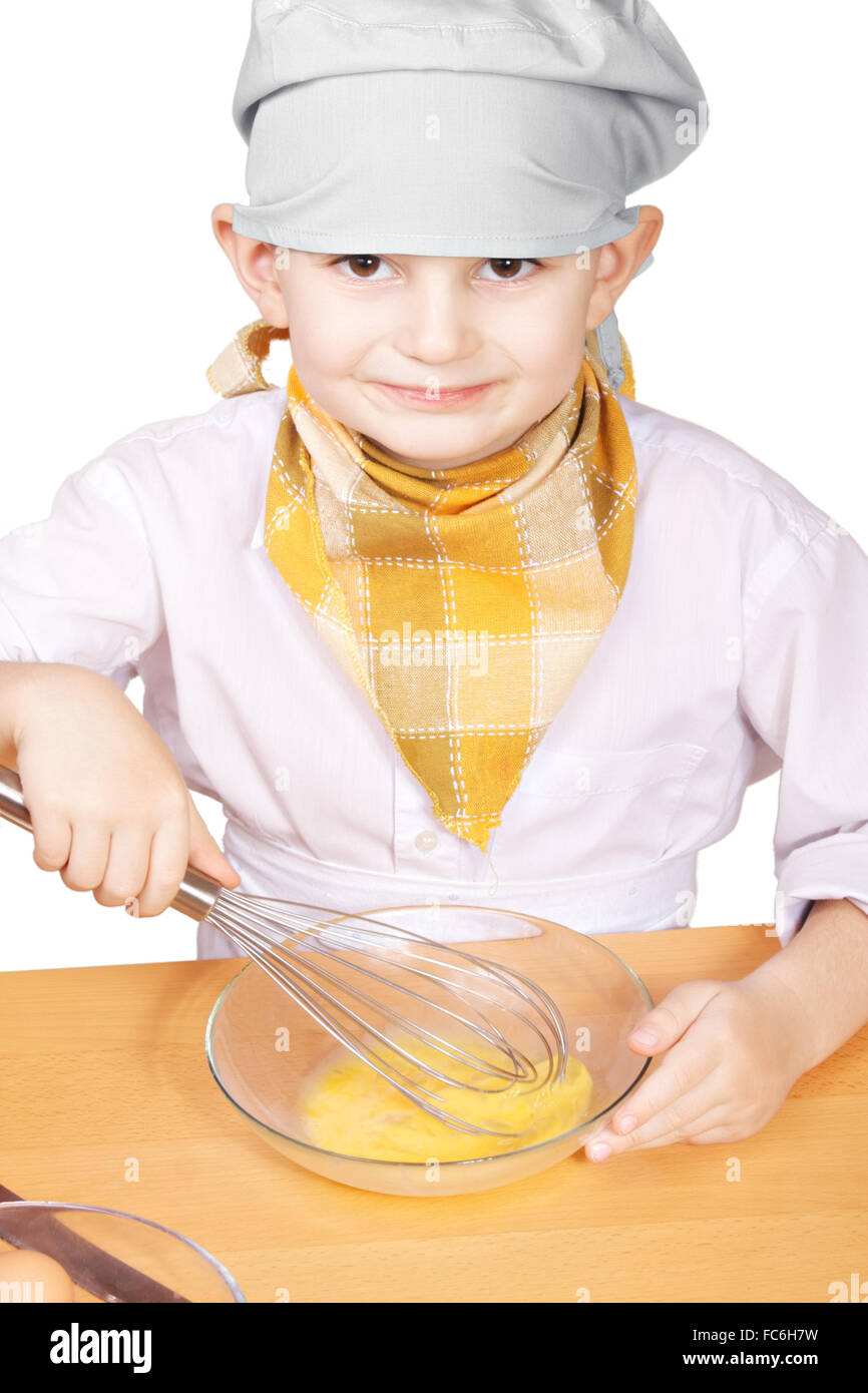 Little smiling cook whisking eggs in a bowl Stock Photo - Alamy