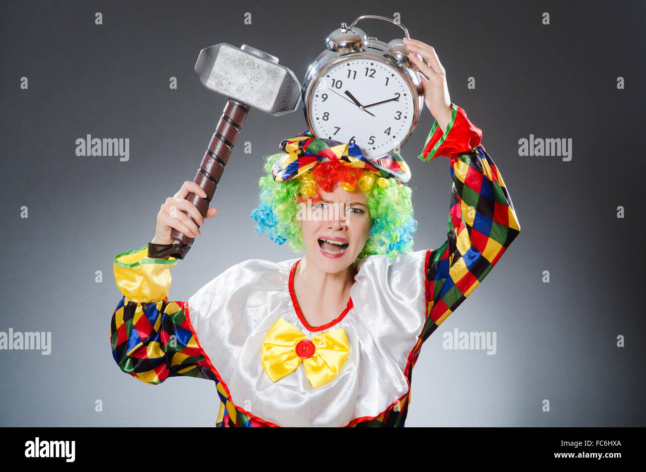 Clown with hammer and clock Stock Photo - Alamy