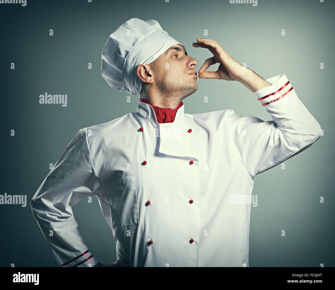 Male chef kissing fingers Stock Photo - Alamy