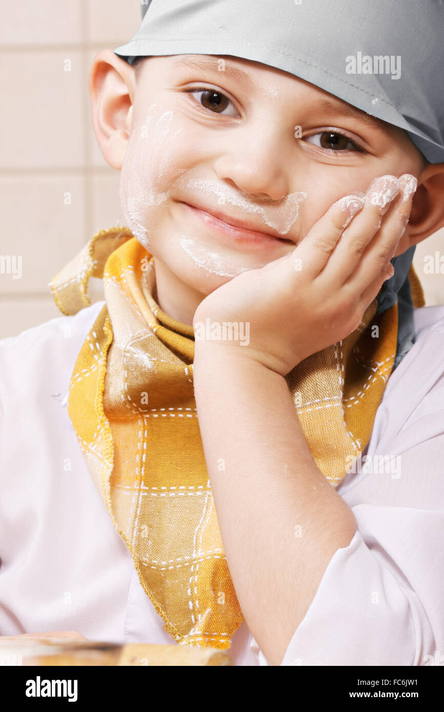 Cute boy leaning on hand Stock Photo - Alamy
