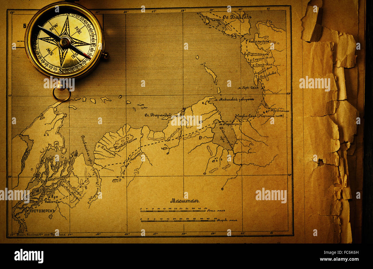 Antique compass over old map Stock Photo - Alamy