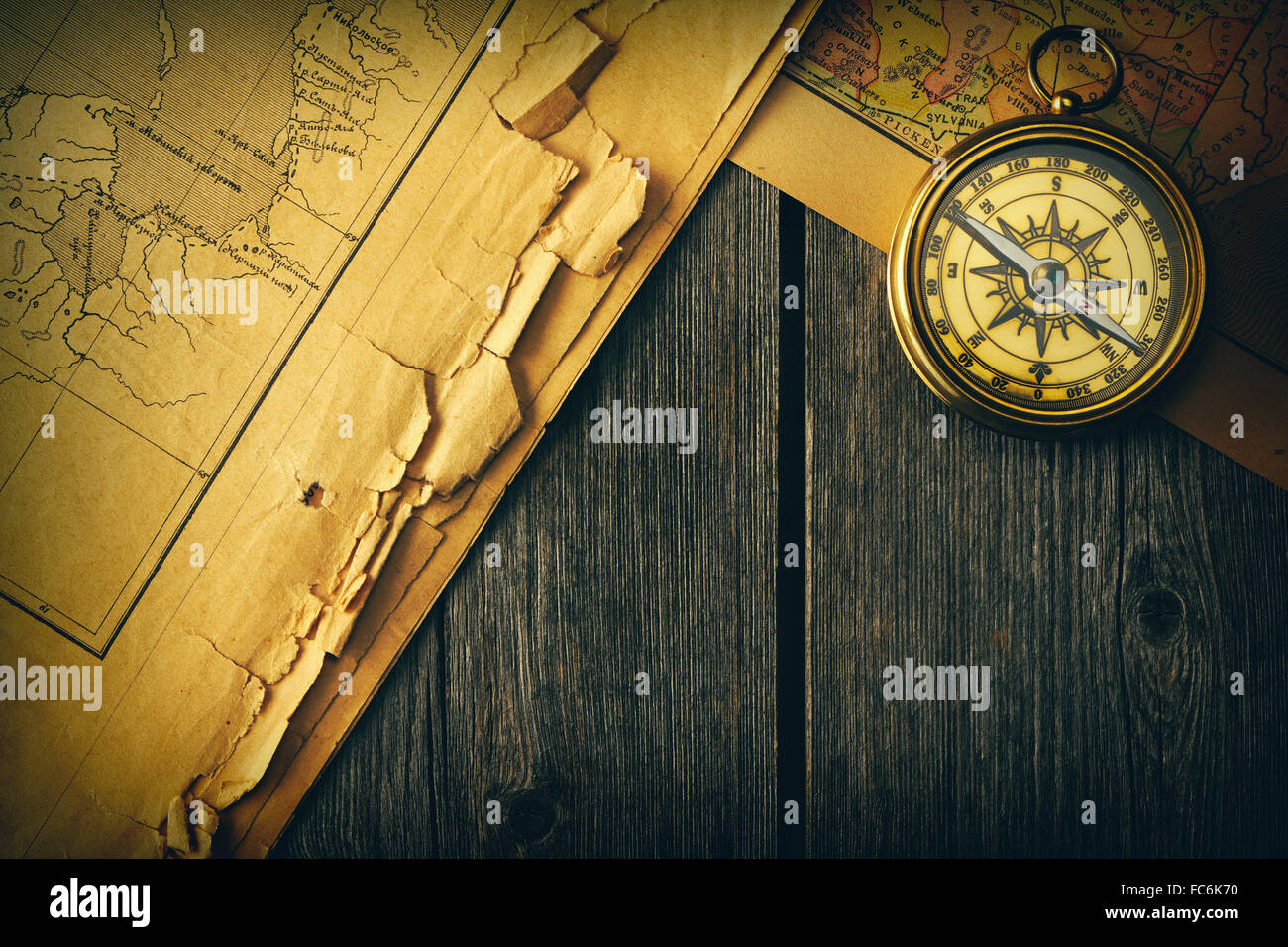 Antique compass over old map Stock Photo - Alamy