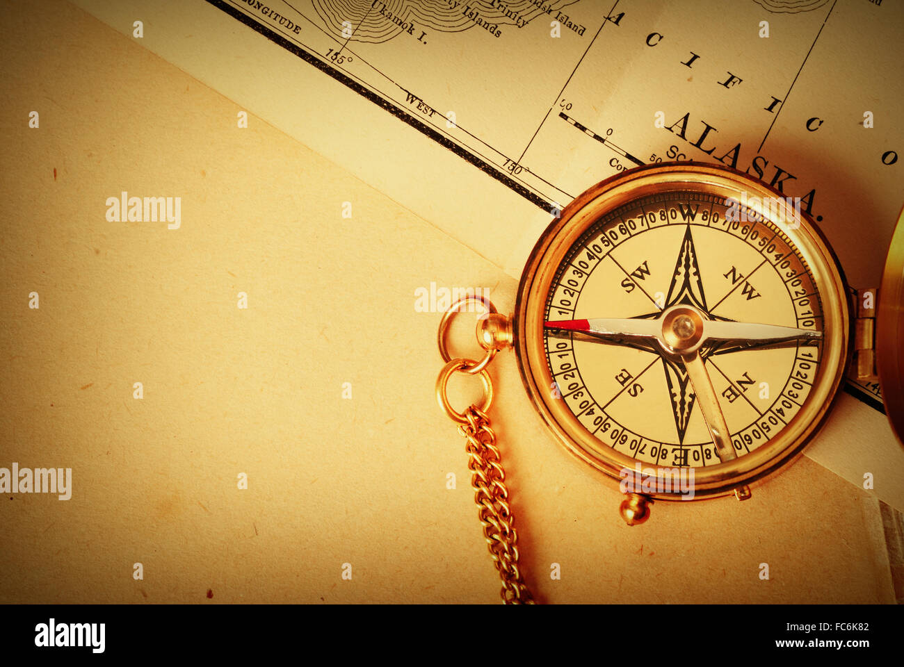 Antique brass compass over old map Stock Photo - Alamy