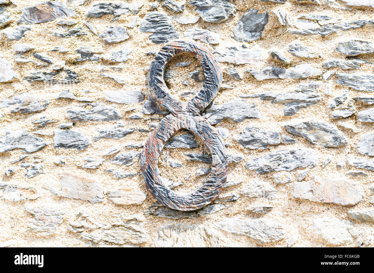 Stone wall with wrought iron number Stock Photo - Alamy