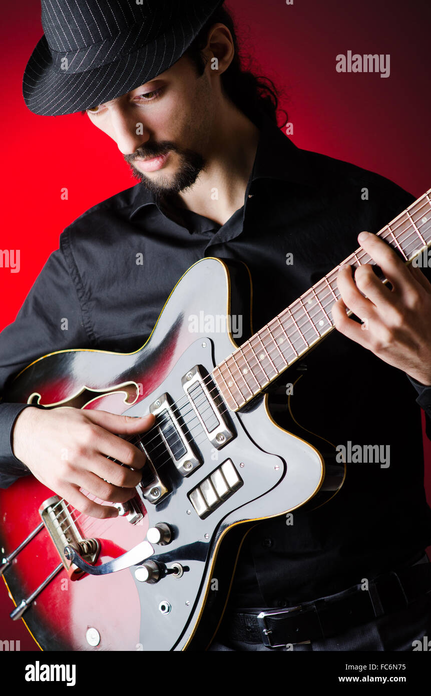 Man with guitar during concert Stock Photo - Alamy