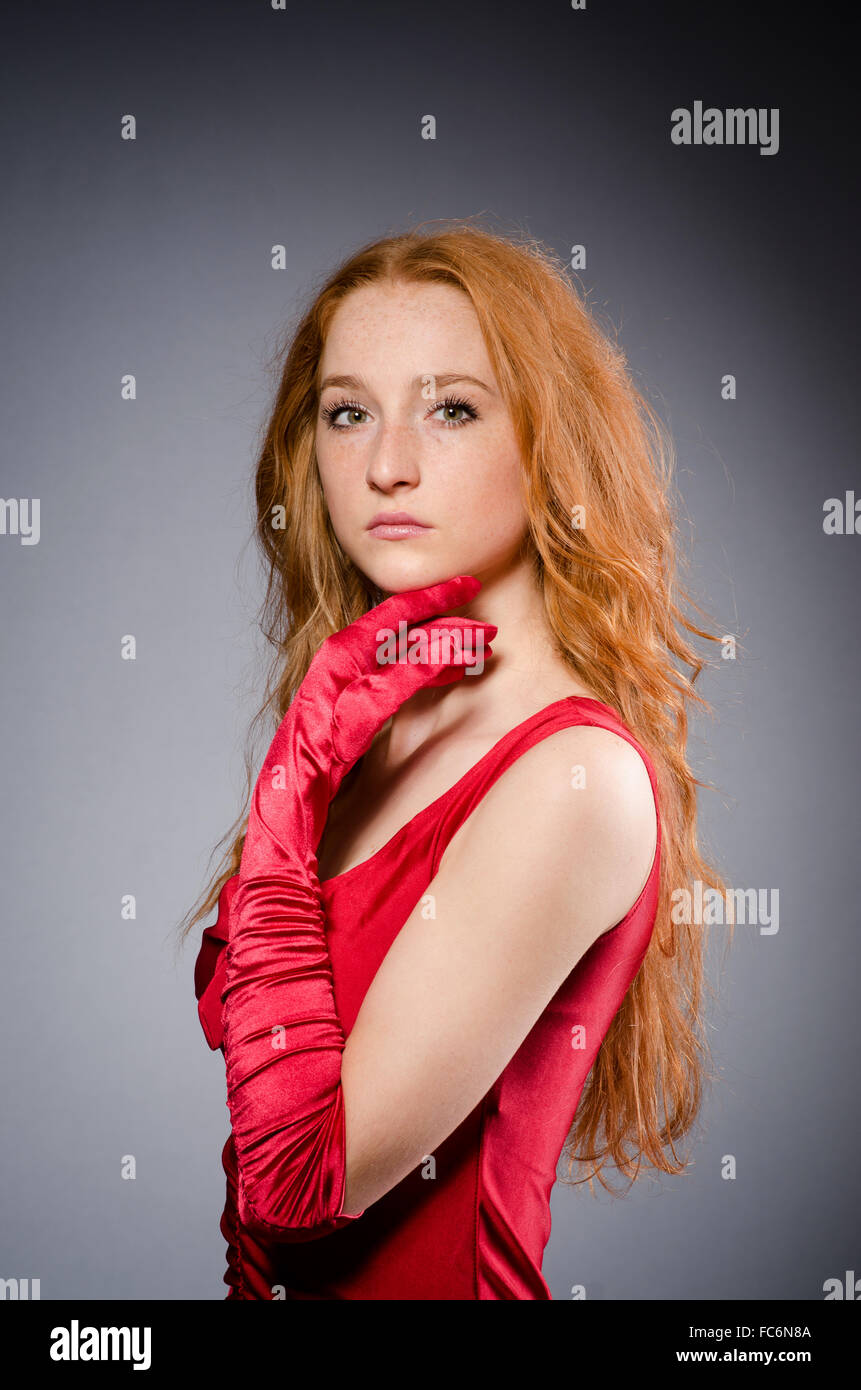 Girl in red dress against gray Stock Photo - Alamy