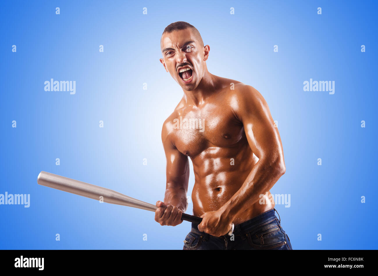 Muscular man with baseball bat Stock Photo - Alamy