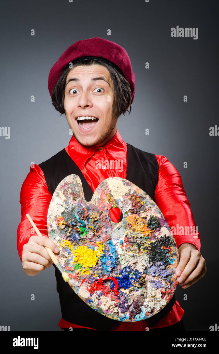 Funny artist in dark studio Stock Photo - Alamy