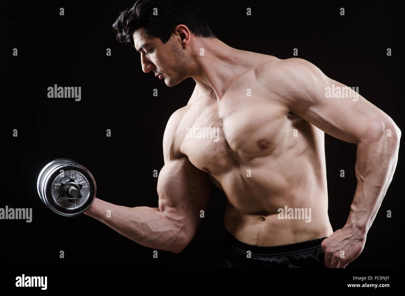 Muscular ripped bodybuilder with dumbbells Stock Photo - Alamy