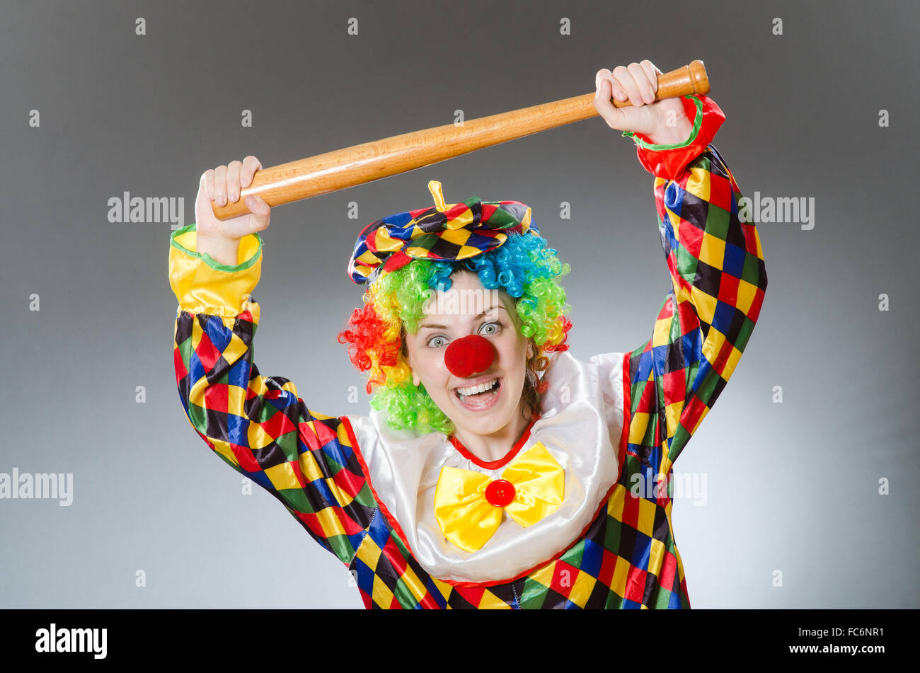 Clown with baseball bat in funny concept Stock Photo - Alamy