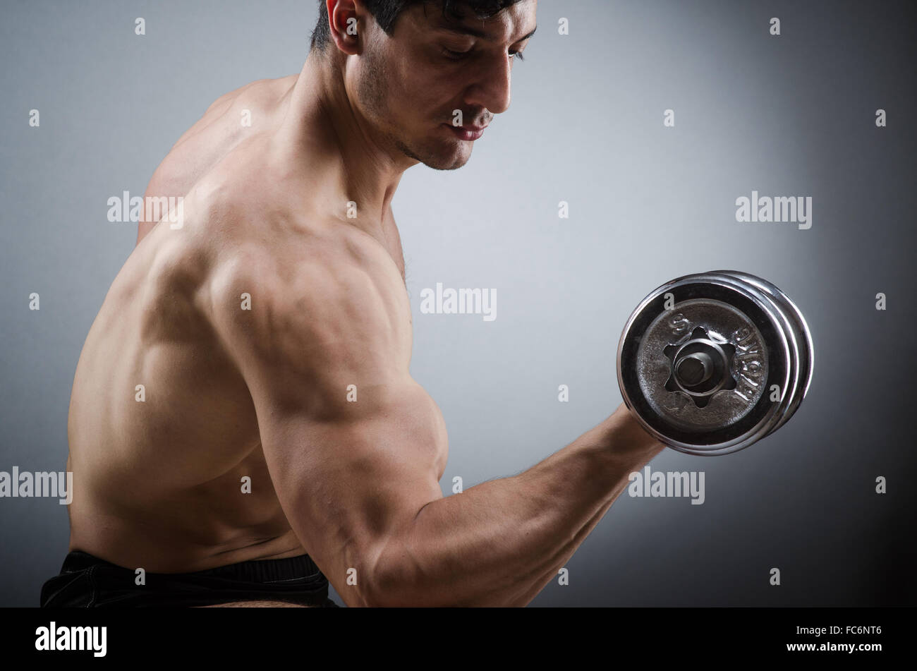 Muscular ripped bodybuilder with dumbbells Stock Photo - Alamy