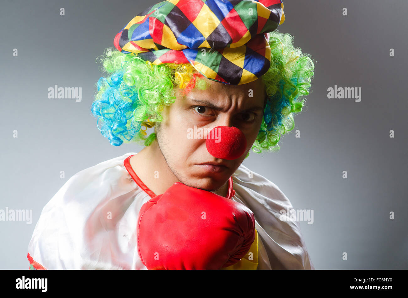 Clown with boxing gloves isolated on white Stock Photo - Alamy