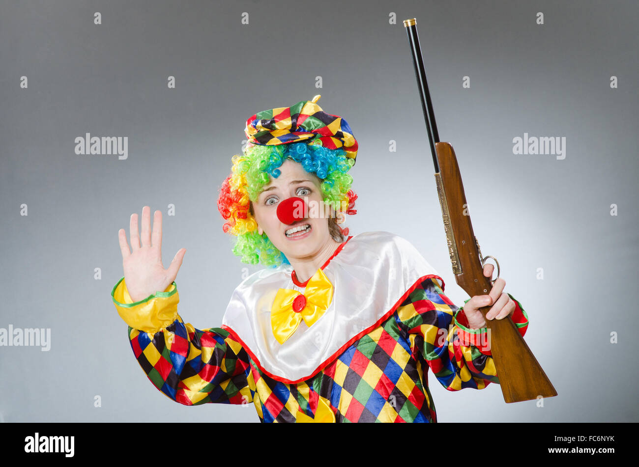 Clown with rifle isolated on white Stock Photo - Alamy