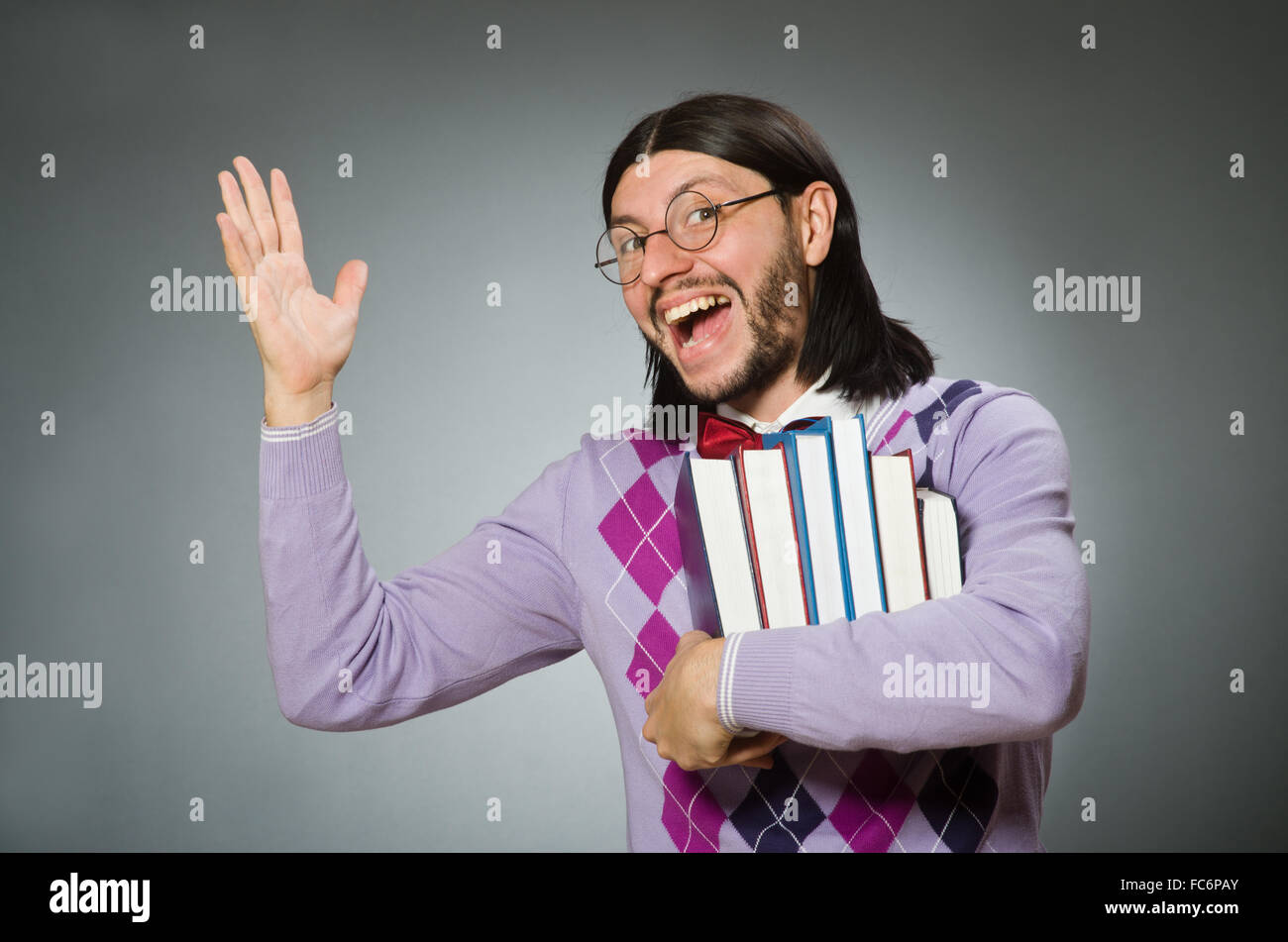 Young student with book in learning concept Stock Photo - Alamy