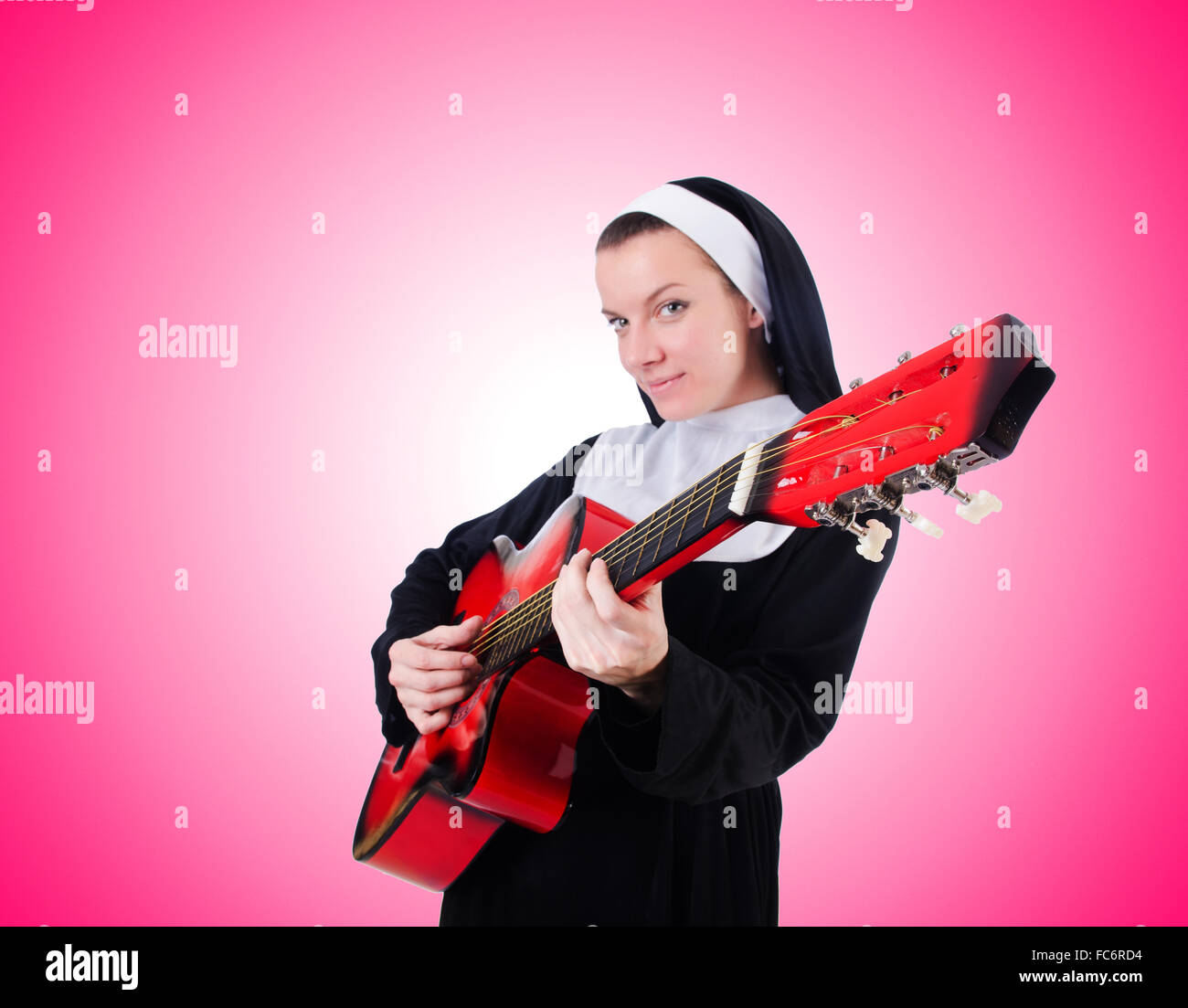 Nun playing guitar against the gradient Stock Photo - Alamy