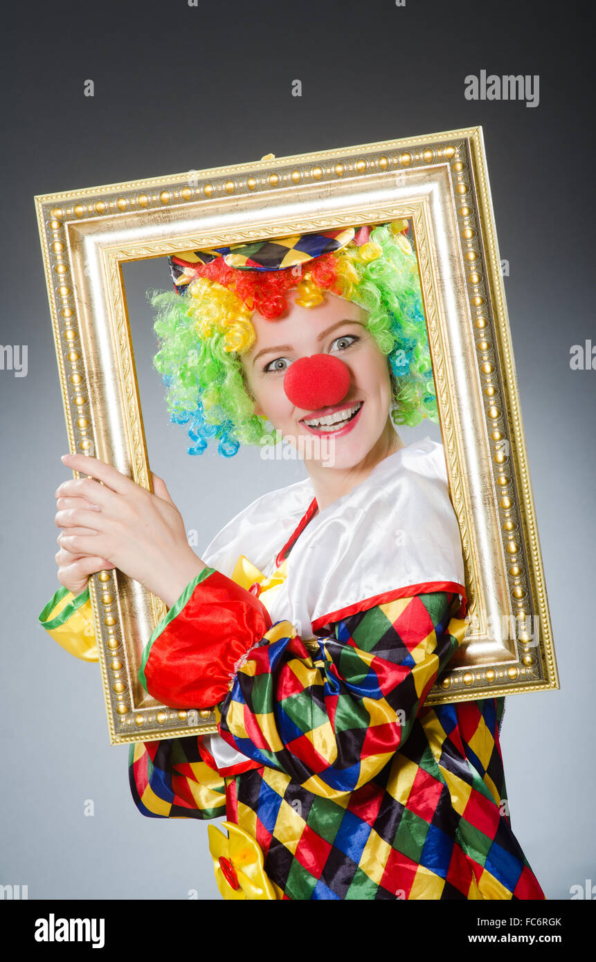 Clown with picture frame in funny concept Stock Photo - Alamy