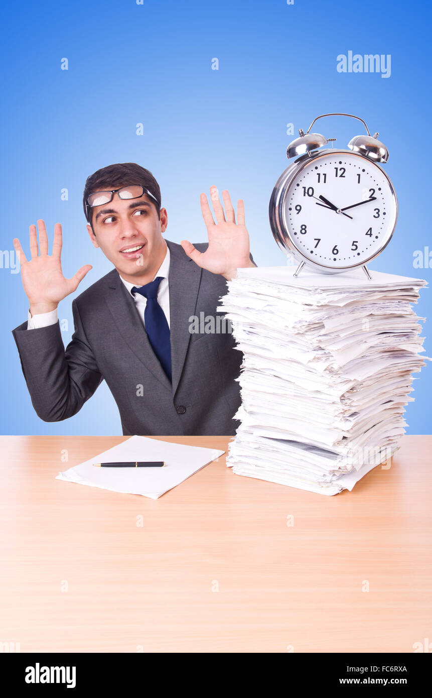 Woman businessman with giant alarm clock Stock Photo - Alamy