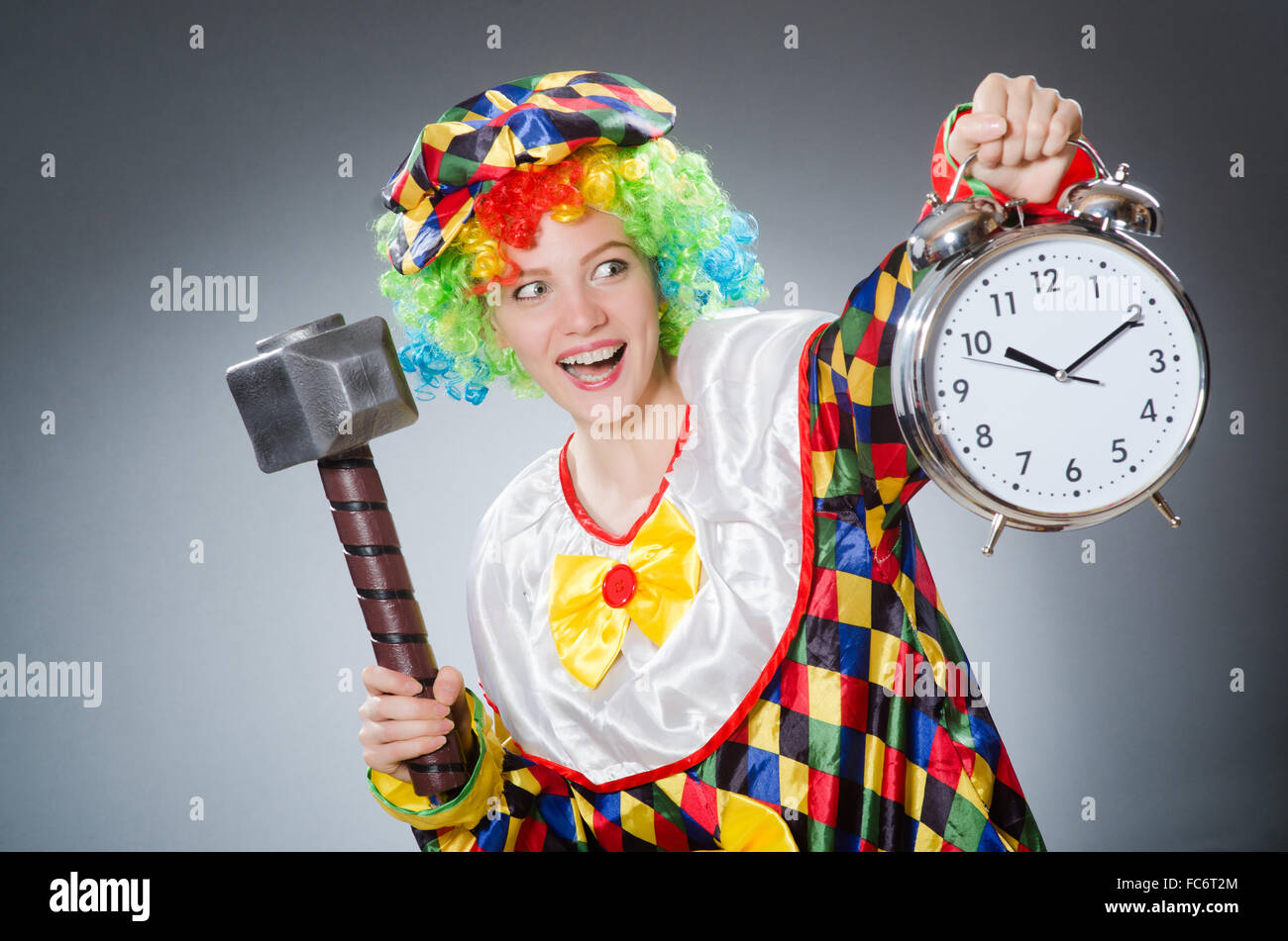 Clown with hammer and clock Stock Photo - Alamy